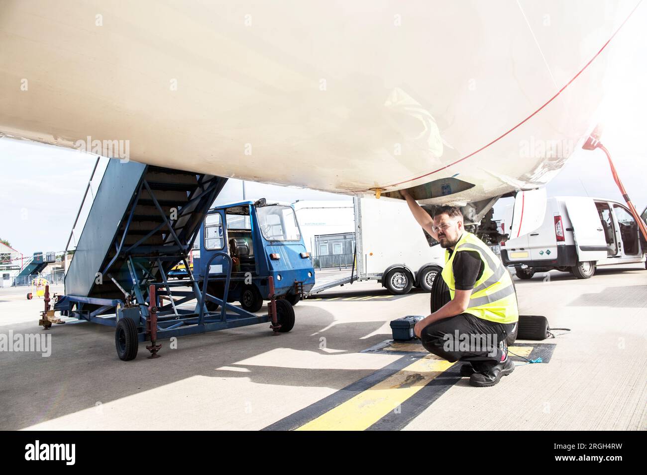 Worker fixing airplane wheel Stock Photo - Alamy