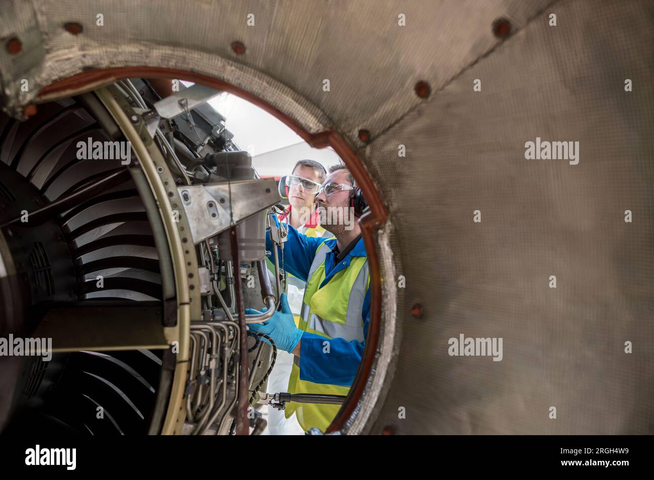 Men working on airplane engine Stock Photo - Alamy