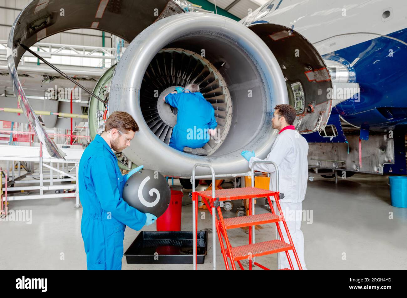 Men working on airplane engine Stock Photo - Alamy