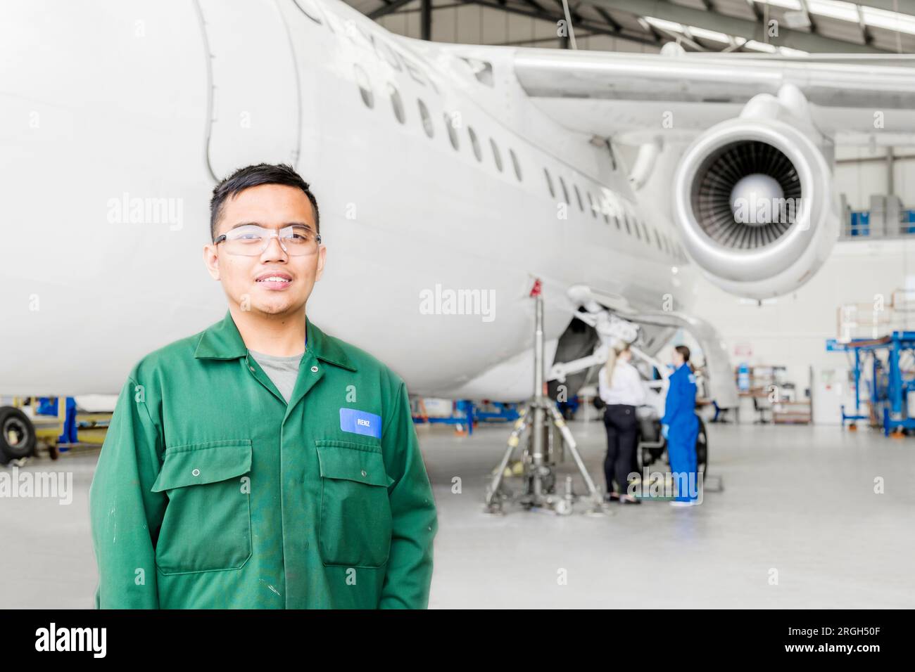 Portrait of male worker in airplane hangar Stock Photo - Alamy