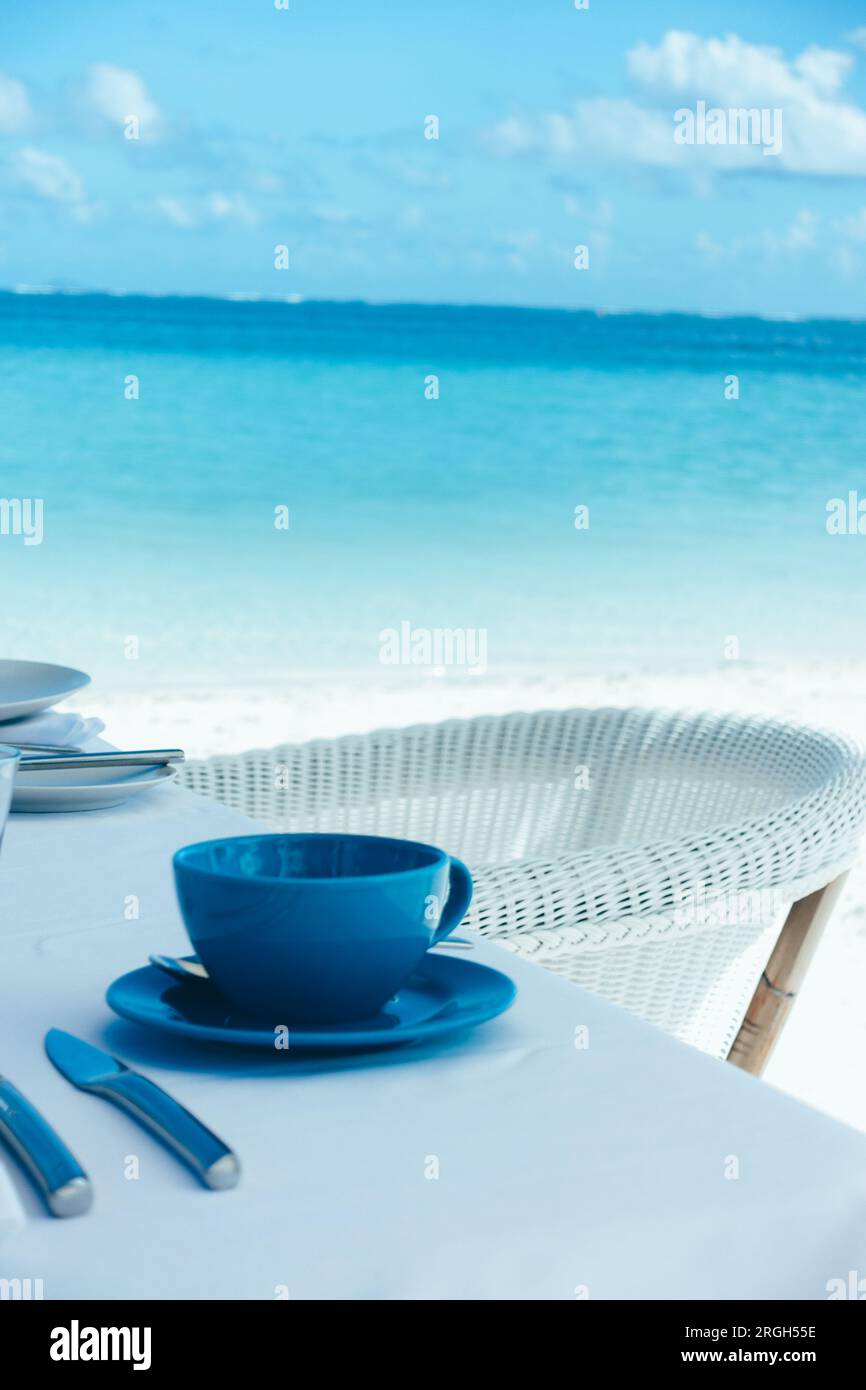 Blue teacup on table on beach Stock Photo - Alamy
