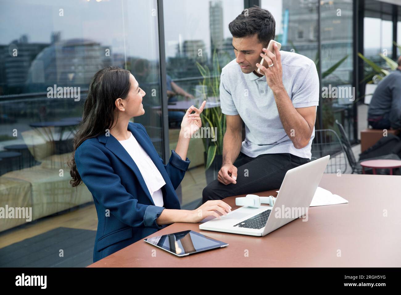 Woman two smartphones laptop hi-res stock photography and images - Alamy
