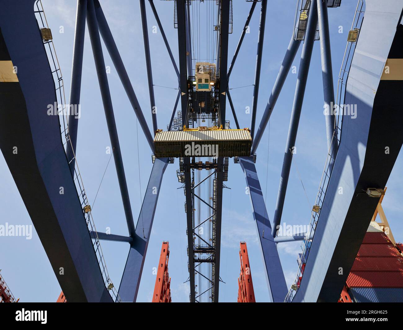 Crane unloading cargo container from ship Stock Photo - Alamy