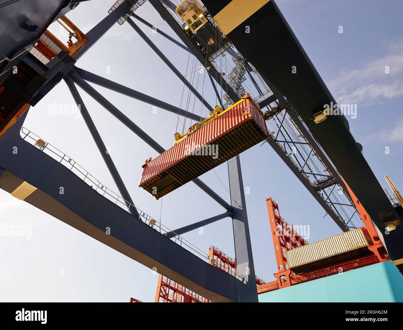 Crane lowering cargo container Stock Photo - Alamy