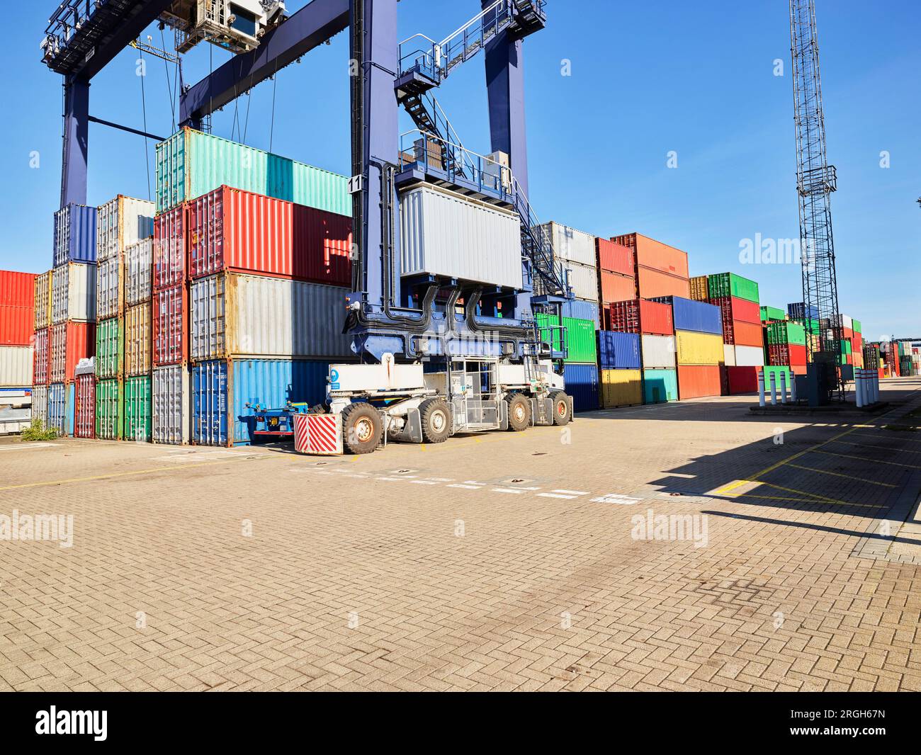 Crane and stacks of cargo containers at Port of Felixstowe, England ...