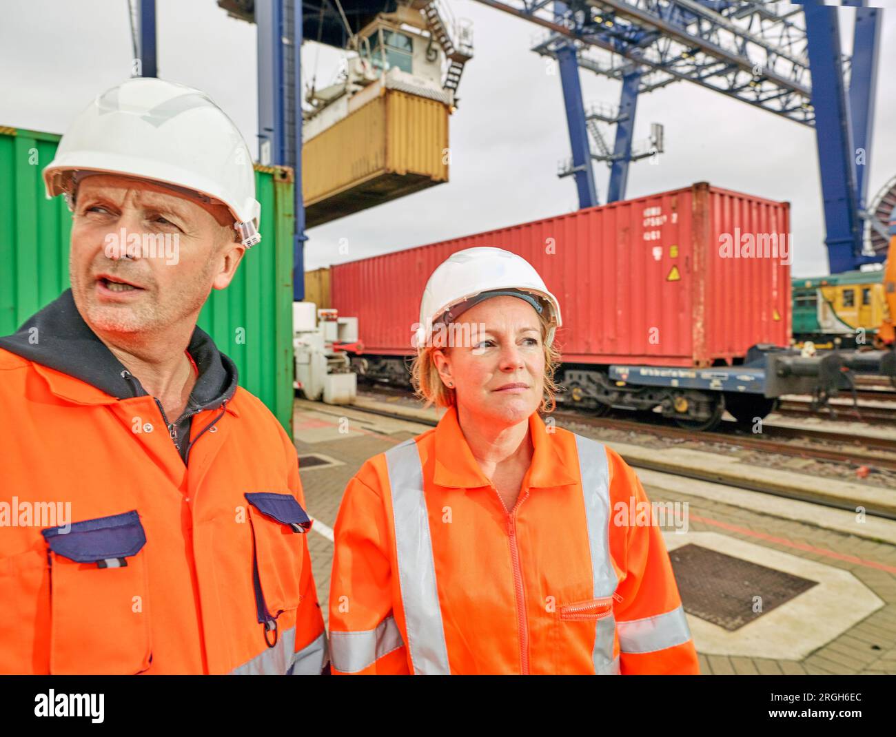Dock workers talking by railway tracks at Port of Felixstowe, England ...