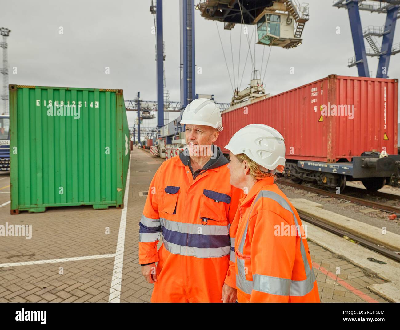 Dock workers talking by railway tracks at Port of Felixstowe, England ...