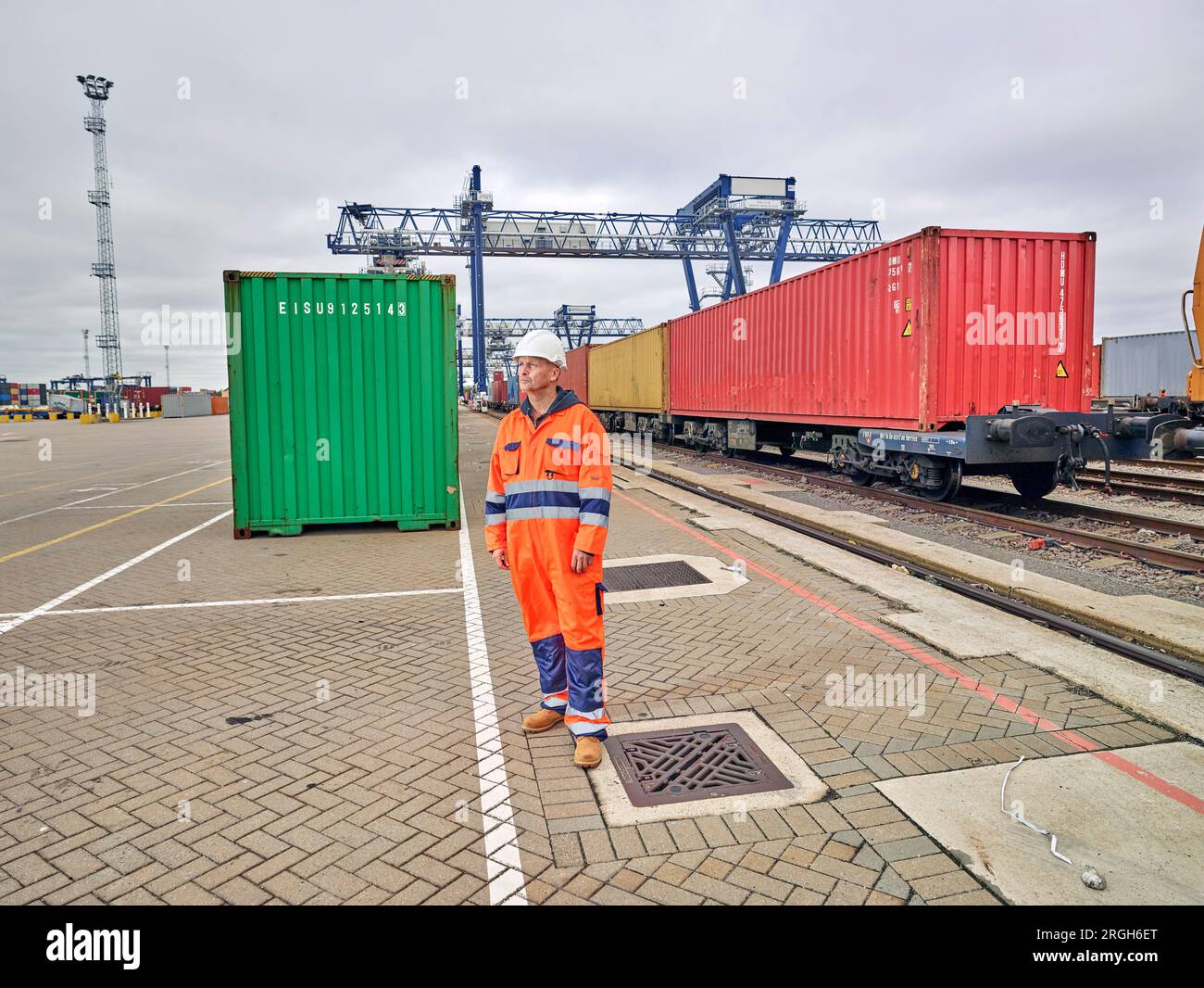 Dock worker by cargo train Stock Photo - Alamy