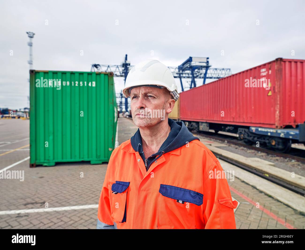 Dock worker by cargo train Stock Photo - Alamy