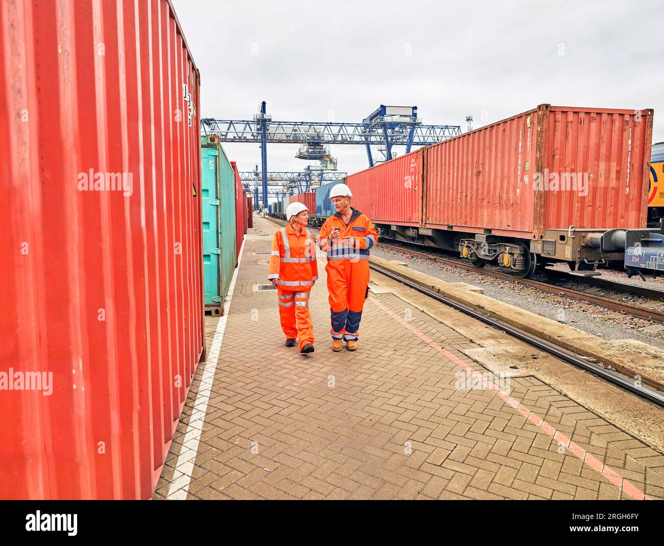 Dock workers by cargo train Stock Photo - Alamy