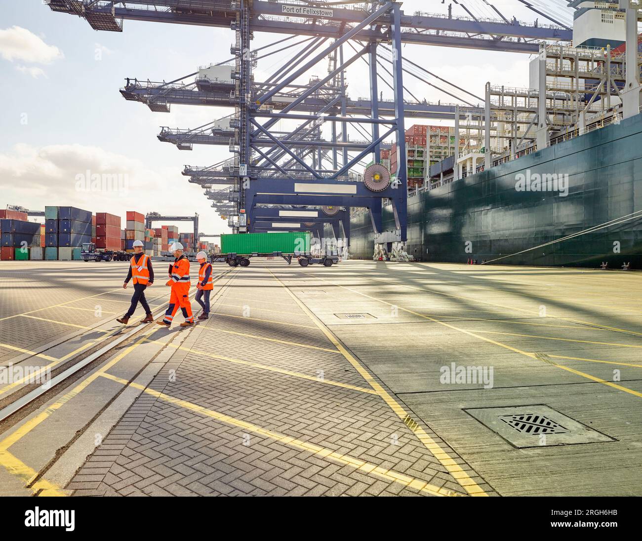 Dock workers beside cargo ship at Port of Felixstowe, England Stock ...