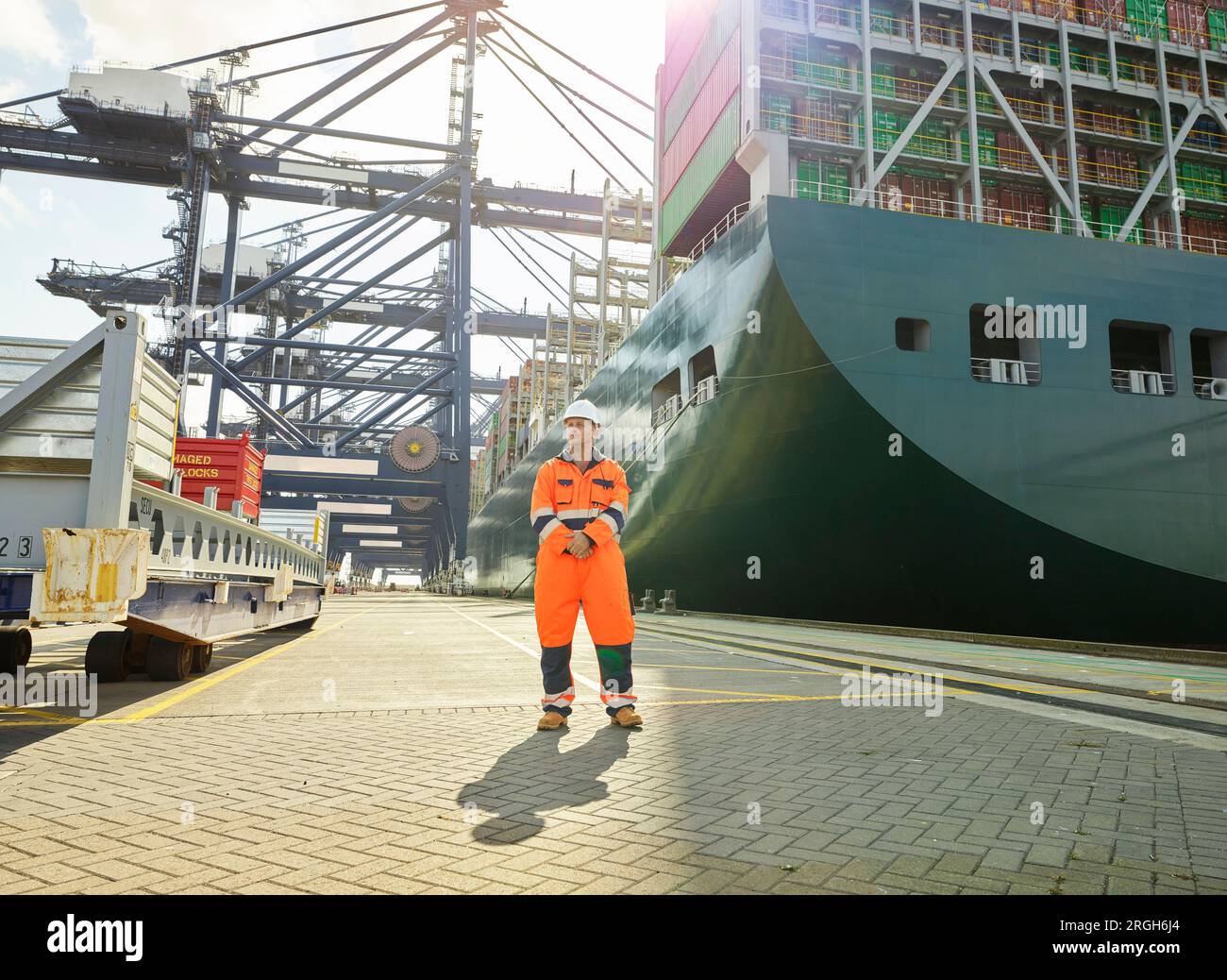 Dock worker beside cargo ship at Port of Felixstowe, England Stock ...