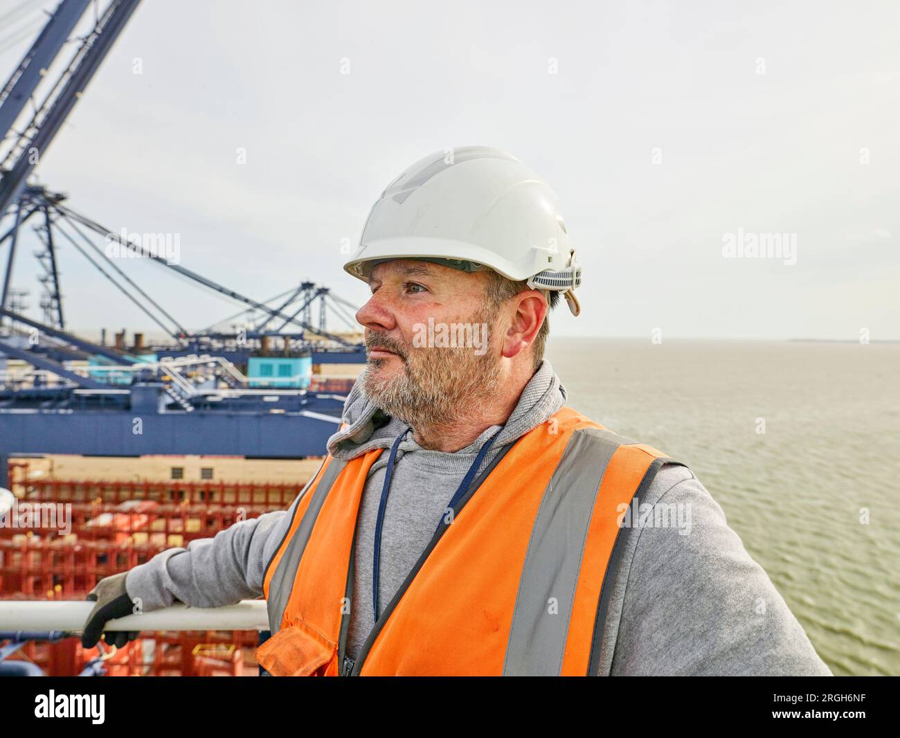 Dock worker with hard hat Stock Photo - Alamy