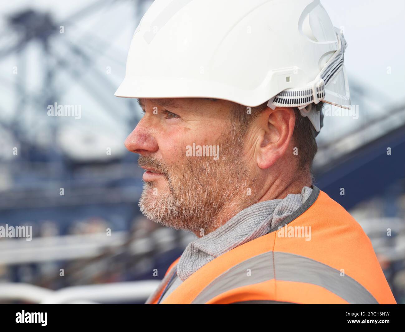 Dock worker with hard hat Stock Photo - Alamy