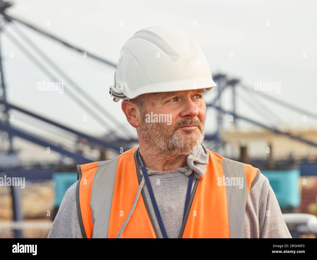 Dock worker with hard hat Stock Photo - Alamy