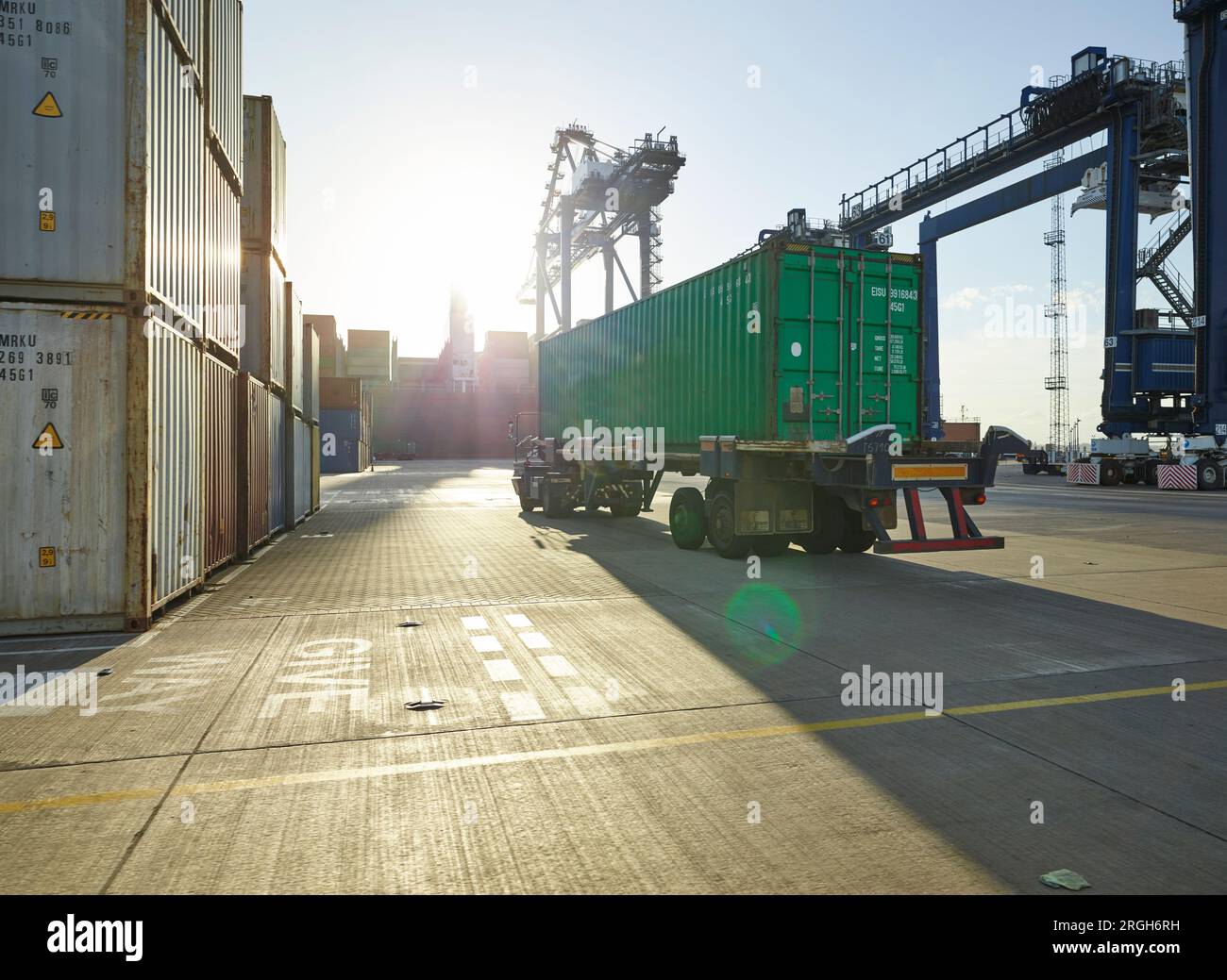 Truck with cargo container on dock Stock Photo - Alamy