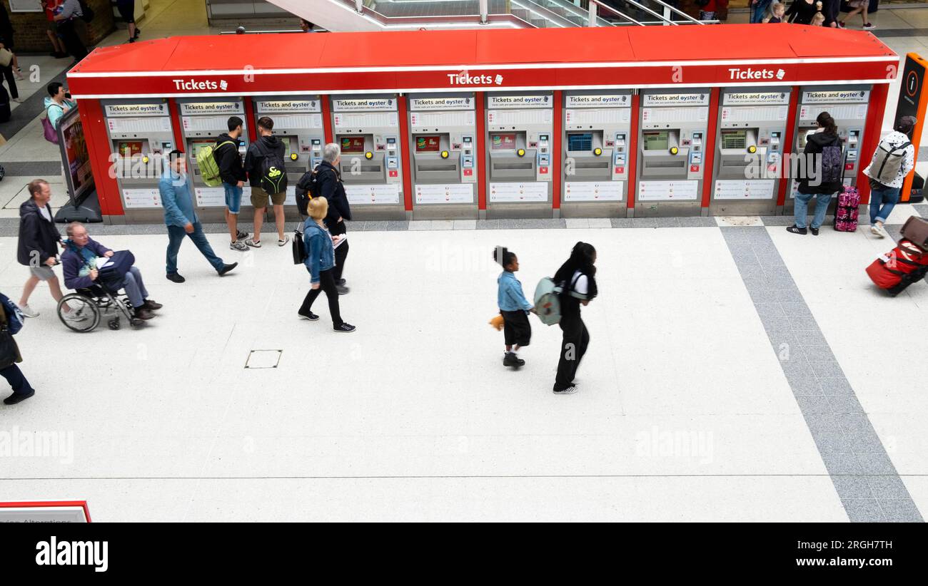 Automated row of ticket machines inside Liverpool Street Station people ...