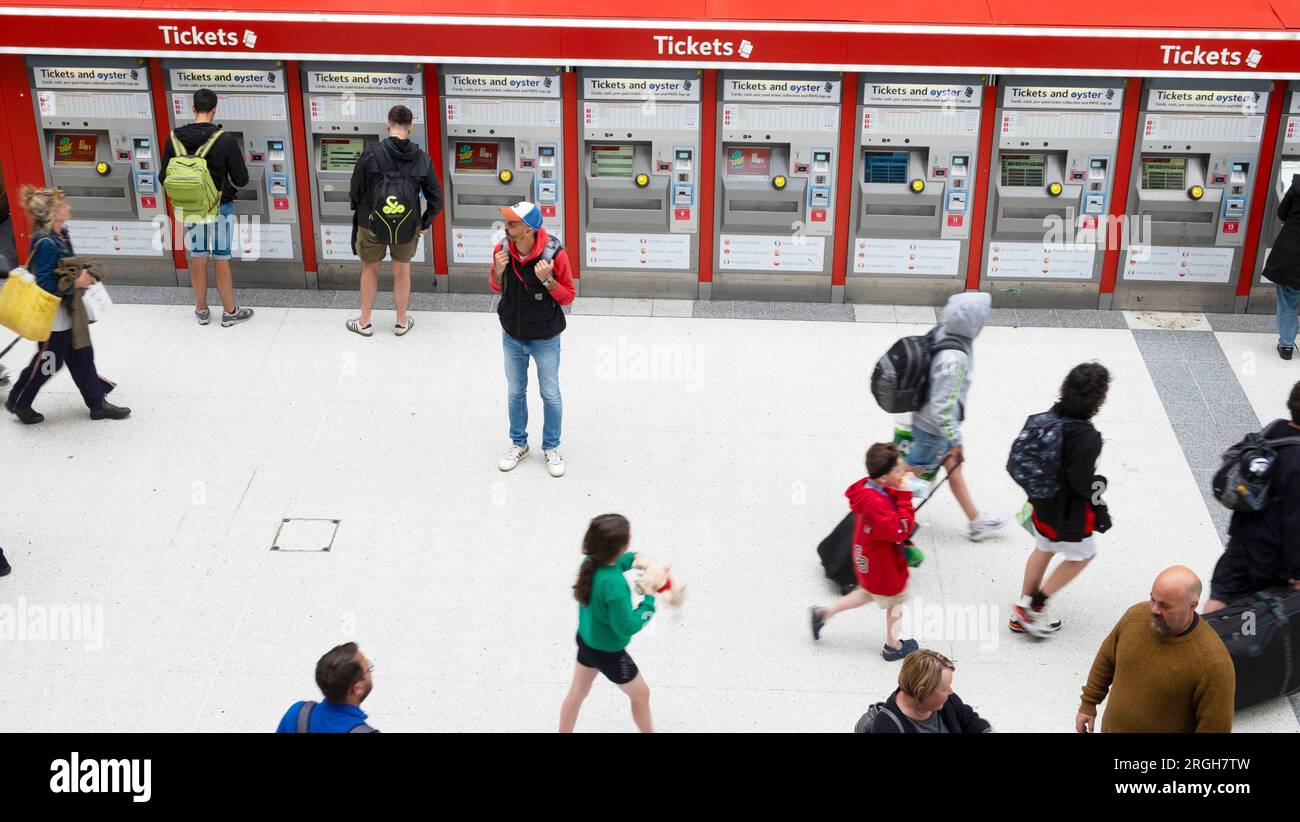 Automated row of ticket machines inside Liverpool Street Station people ...