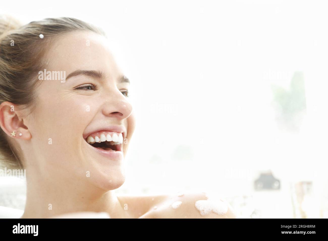 Woman laughing in a bright setting Stock Photo - Alamy