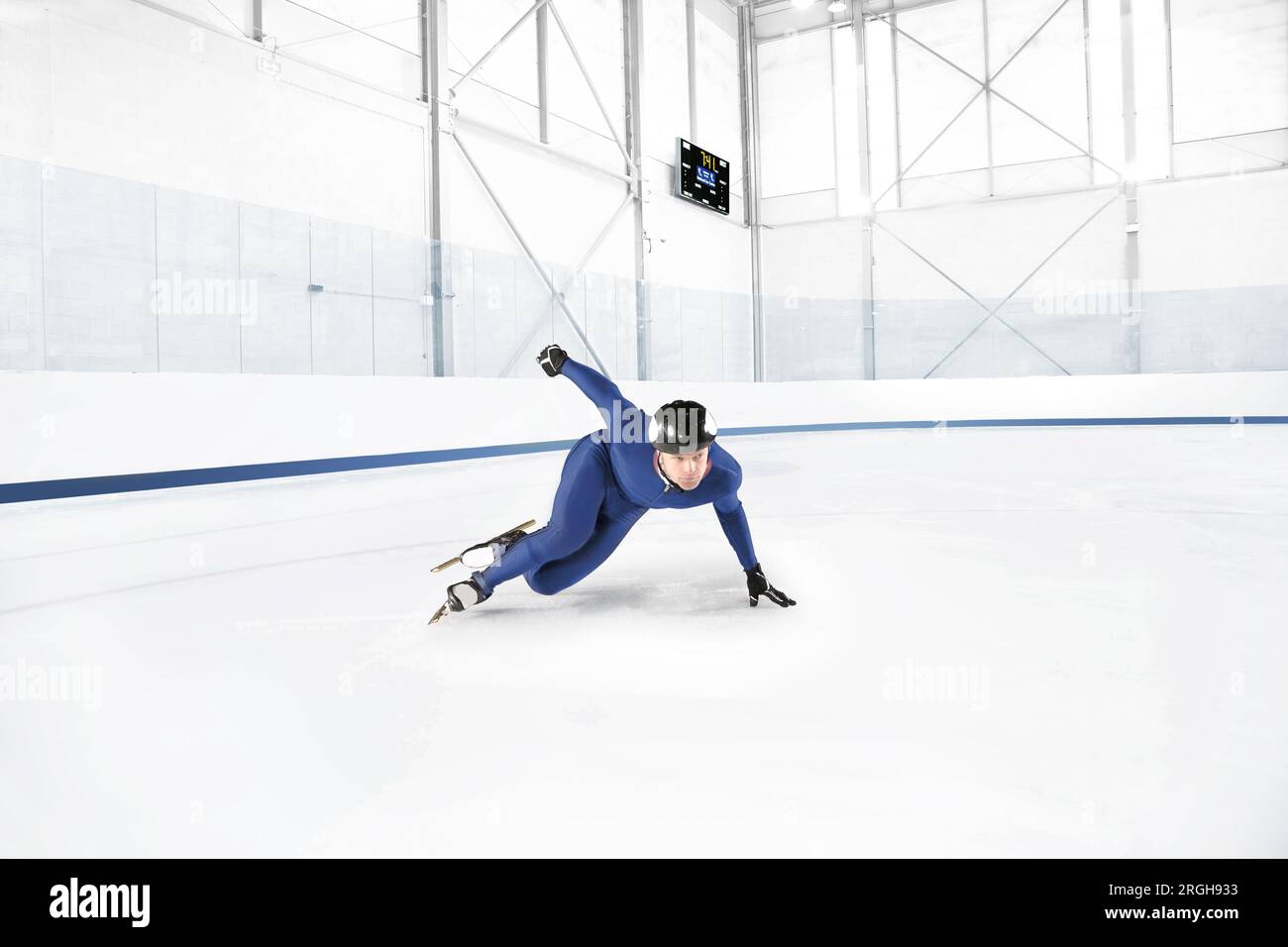 Young man practicing speed skating at ice rink Stock Photo - Alamy