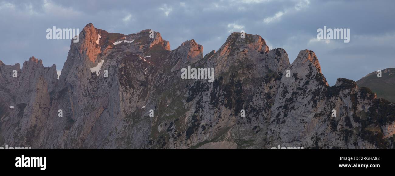 The Saxer Gap in the Swiss Alps is lit up by the sun on a morning Stock ...