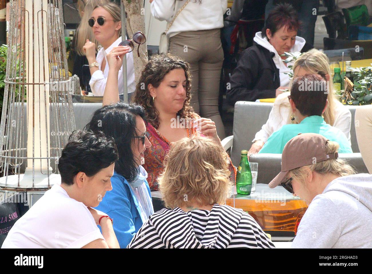 Multi generational groups of tourists enjoying leisure time at a bar ...