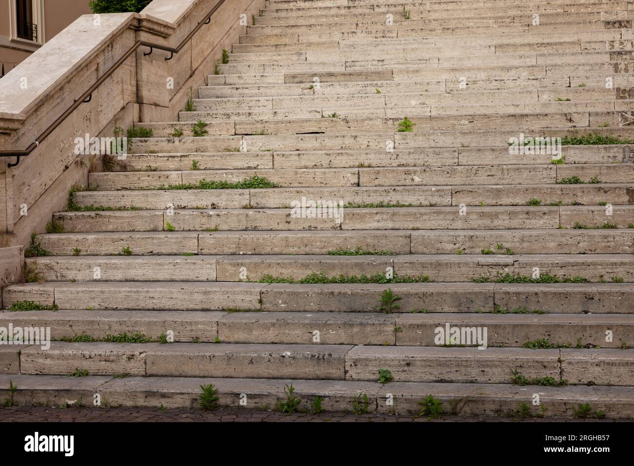 Old steps in Rome Italy with grass growing through the many cracks ...