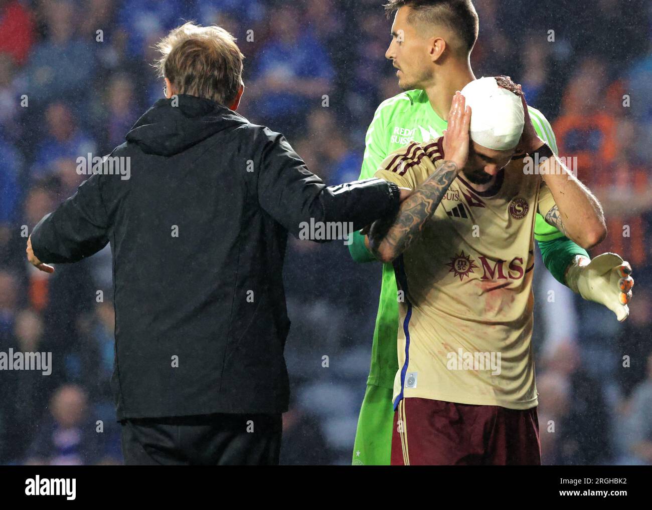 Servette FC's Steve Rouiller leaves the pitch with his head bandaged ...