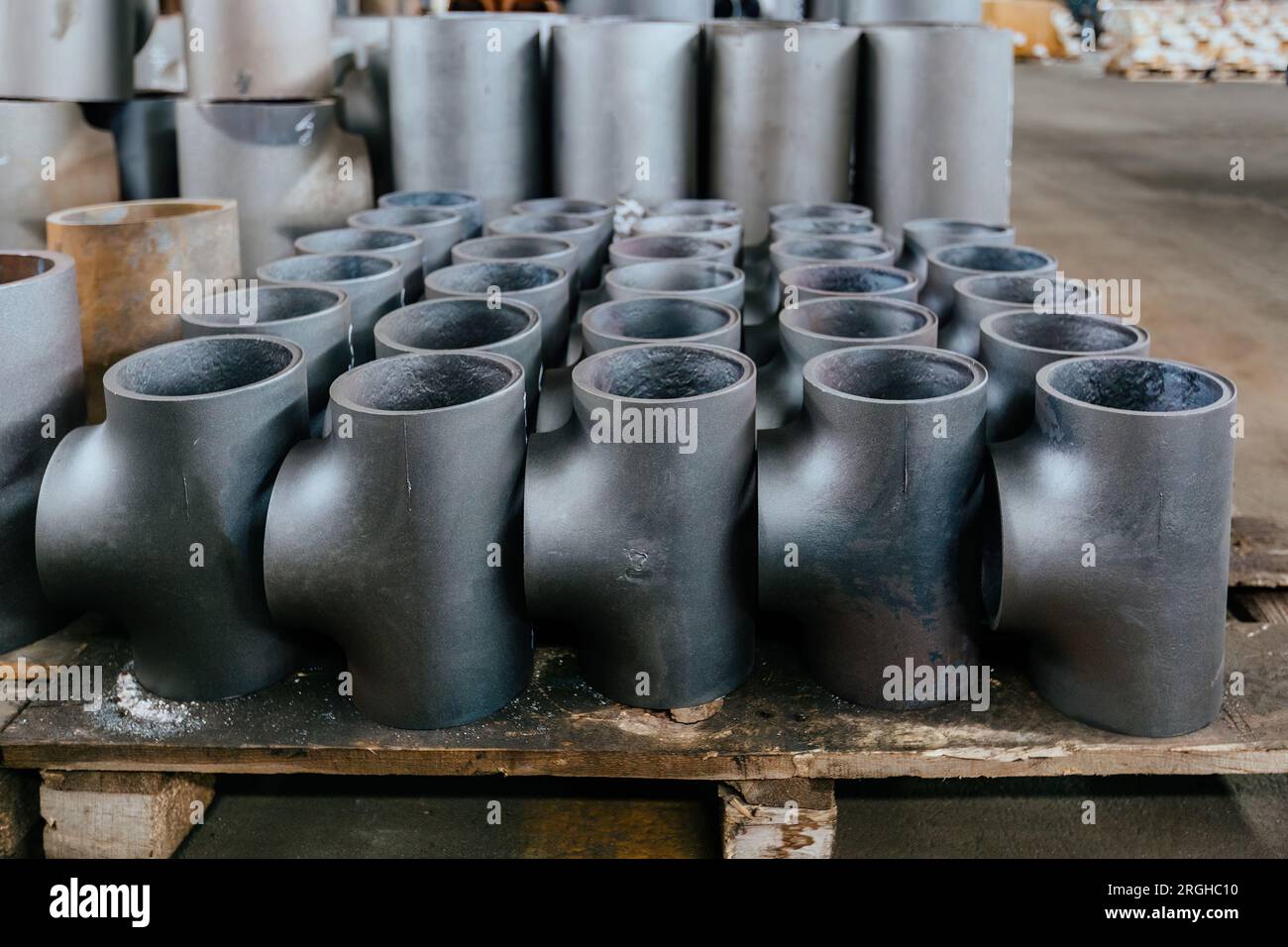 Batch of T shape pipe parts in warehouse Stock Photo - Alamy