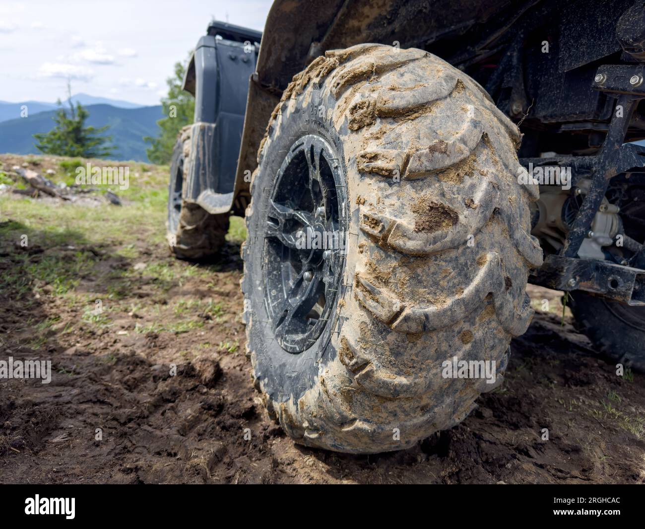 Riding a ATV in the mountains close-up of the wheel Stock Photo - Alamy