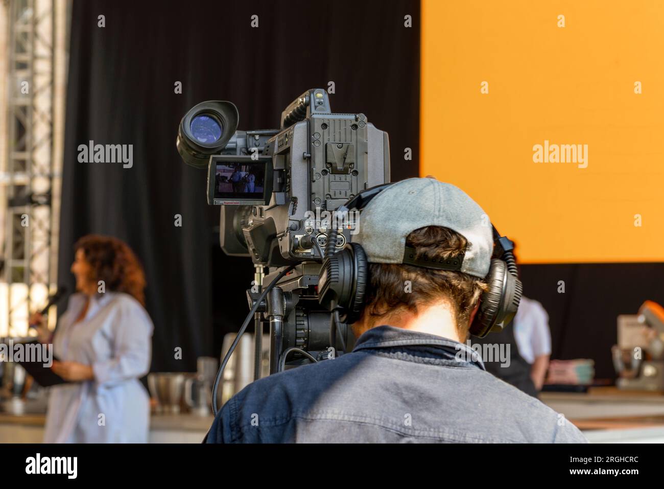 Cameraman at event. Professional cameraman with headphones with ...