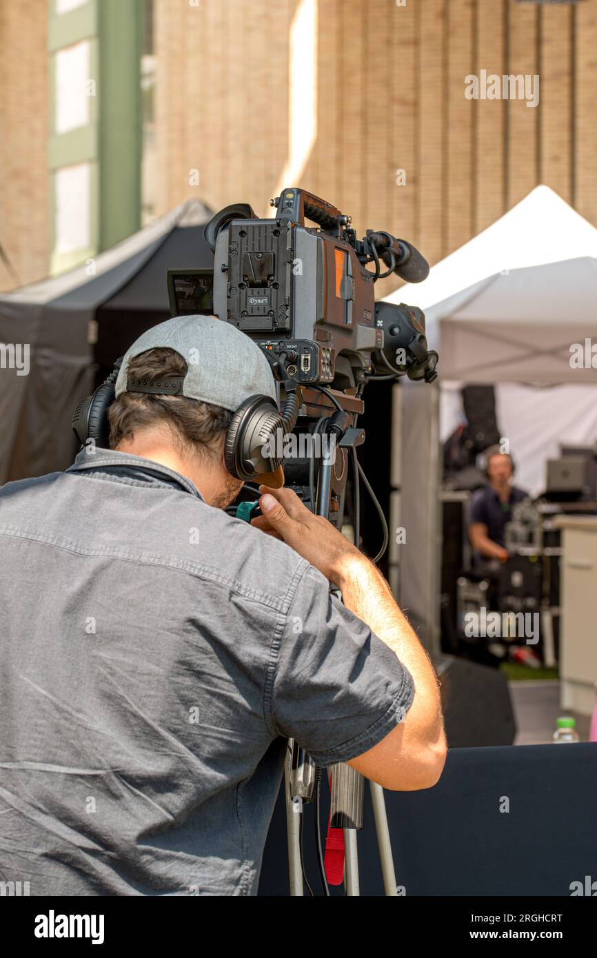 Cameraman at event. Professional cameraman with headphones with ...