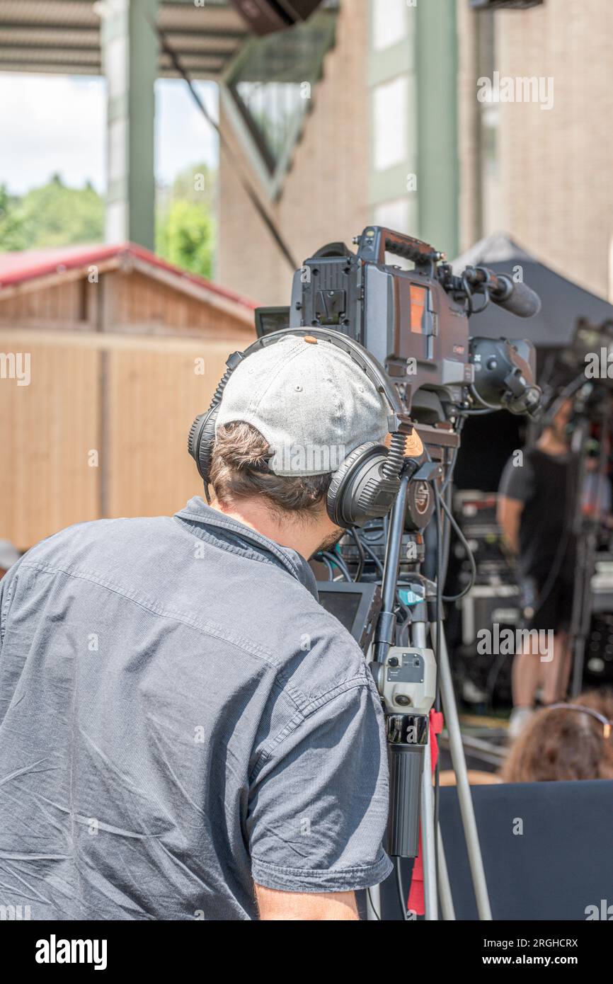 Cameraman at event. Professional cameraman with headphones with ...