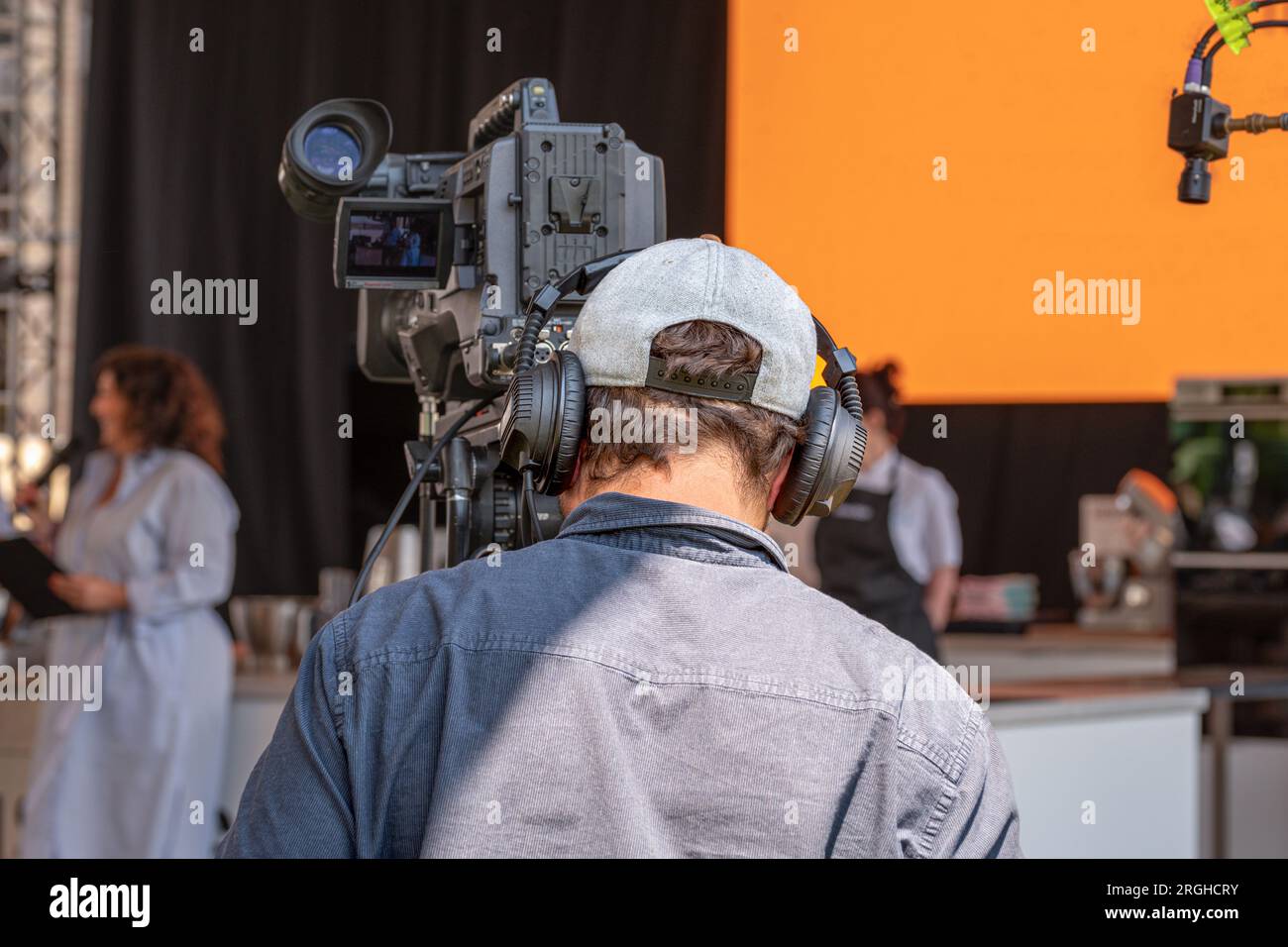 Cameraman at event. Professional cameraman with headphones with ...