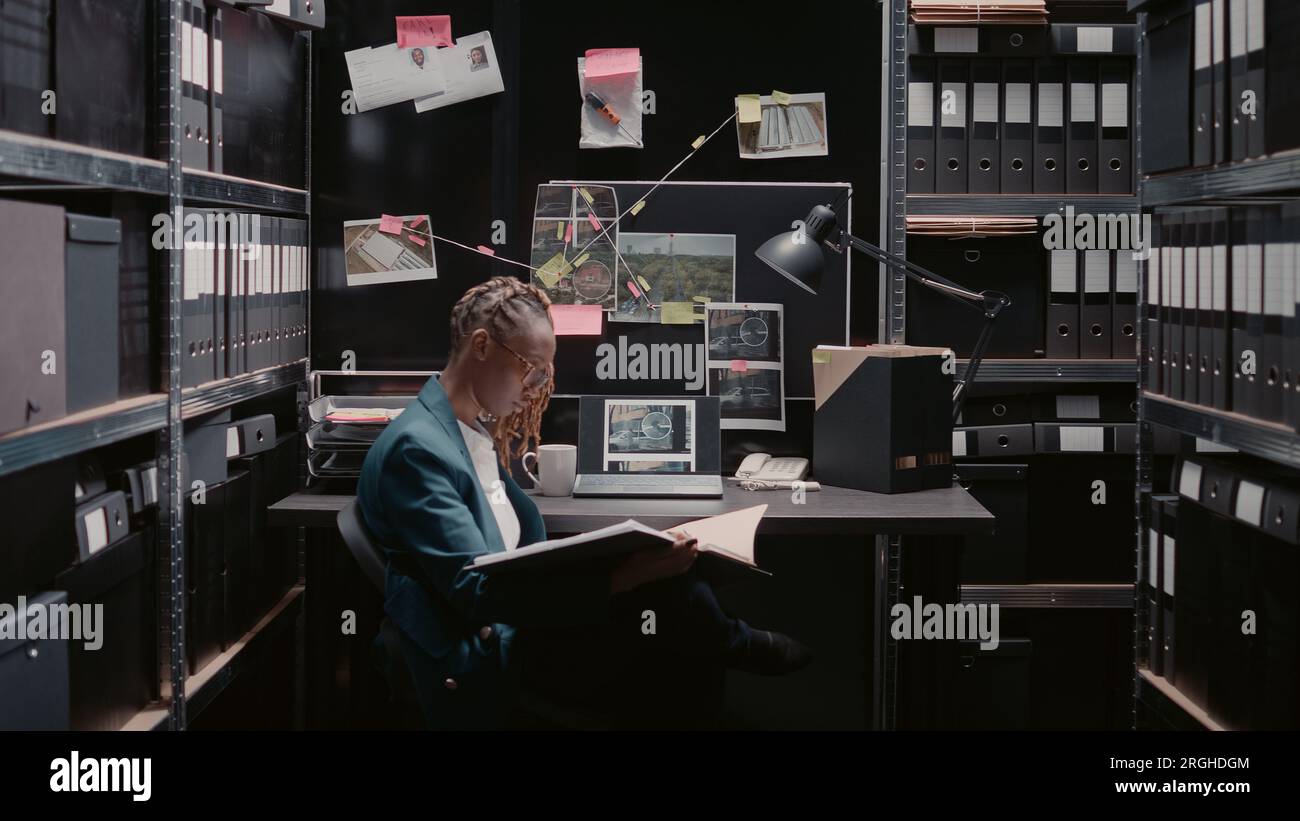 Private investigator reviewing new case evidence on detective board ...