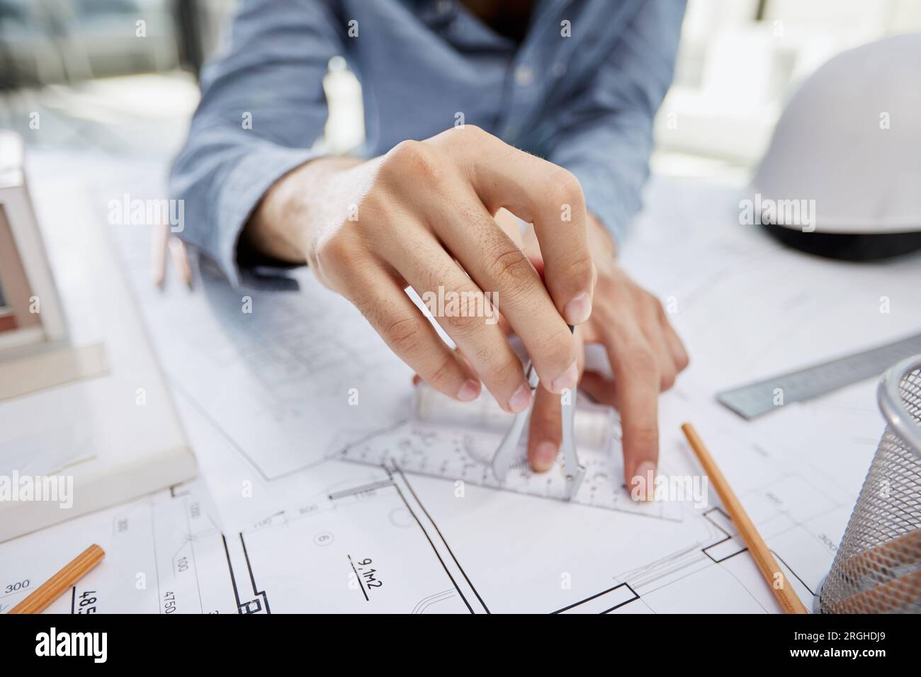 Architect working on drawing table in office Stock Photo - Alamy