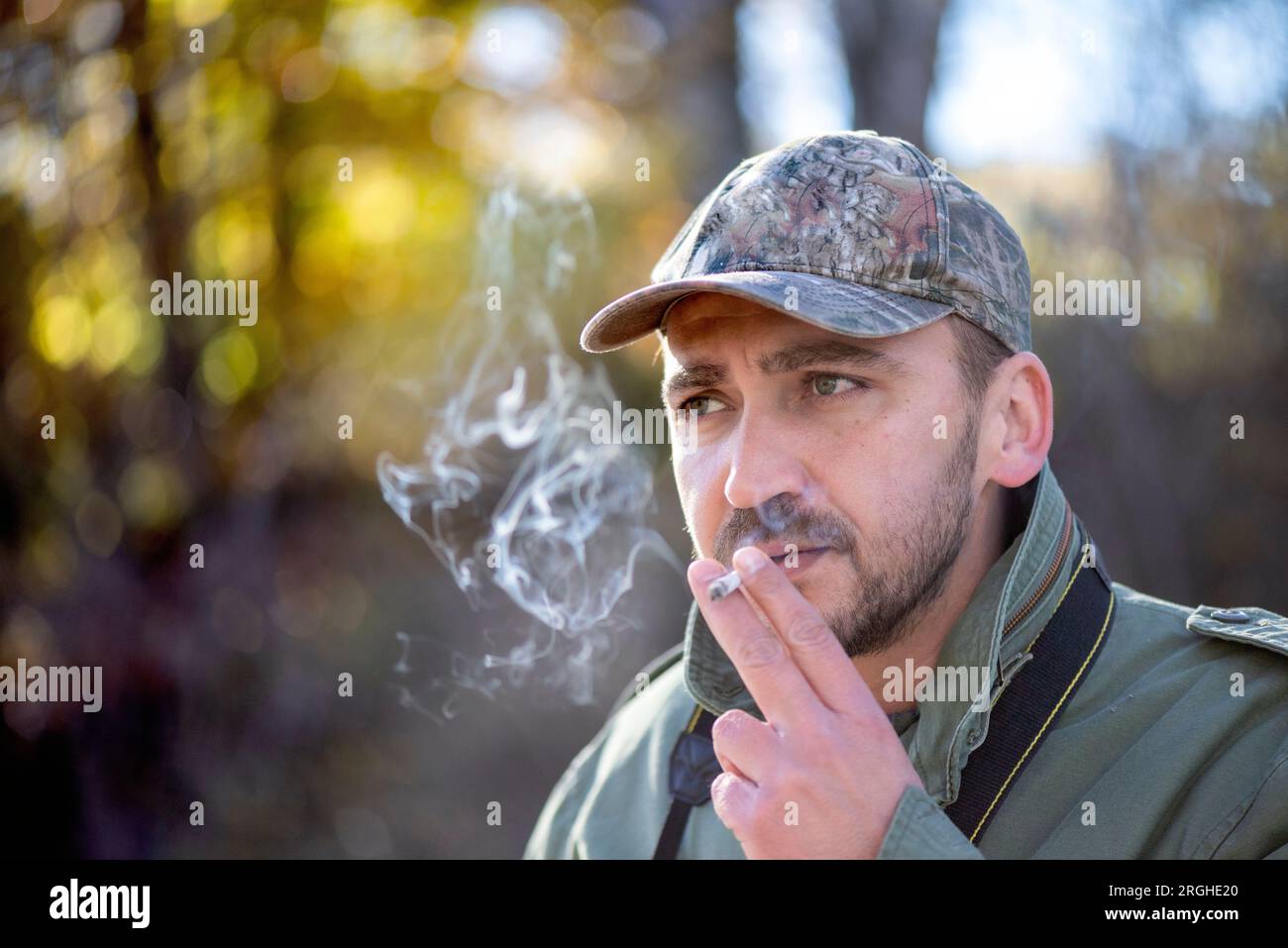 portrait of a young man with a cigarette, smoking cigarettes bad habit ...