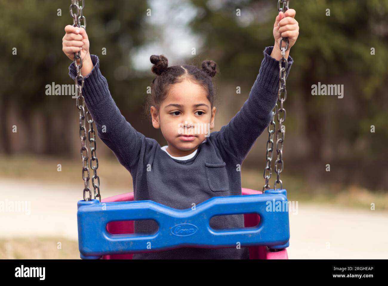 girl swinging outside, with dreamy face expression Stock Photo - Alamy