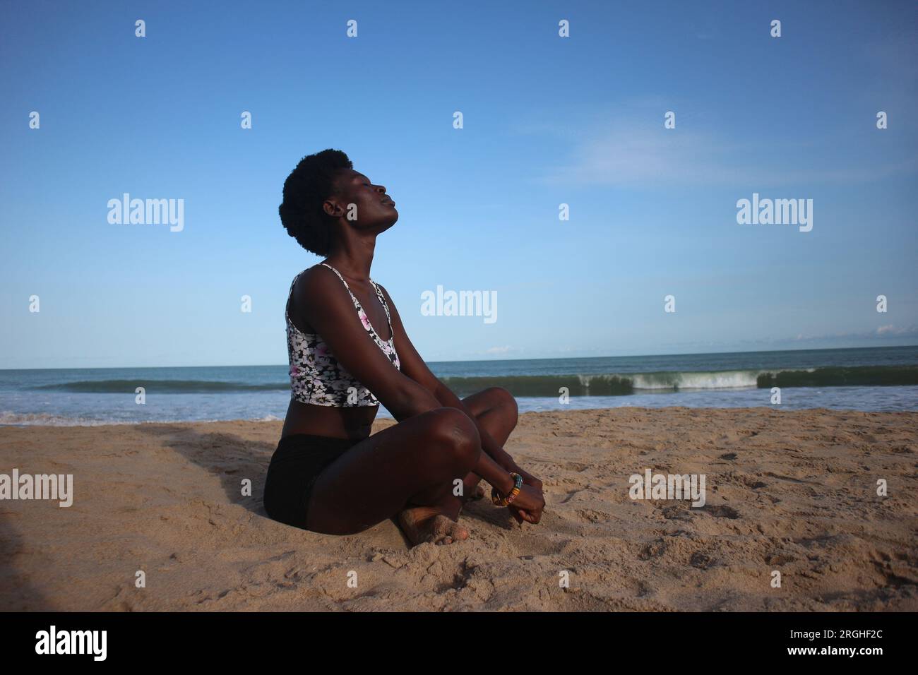 Sandy Asana: Beachside Yoga Pose of an African Woman Stock Photo - Alamy