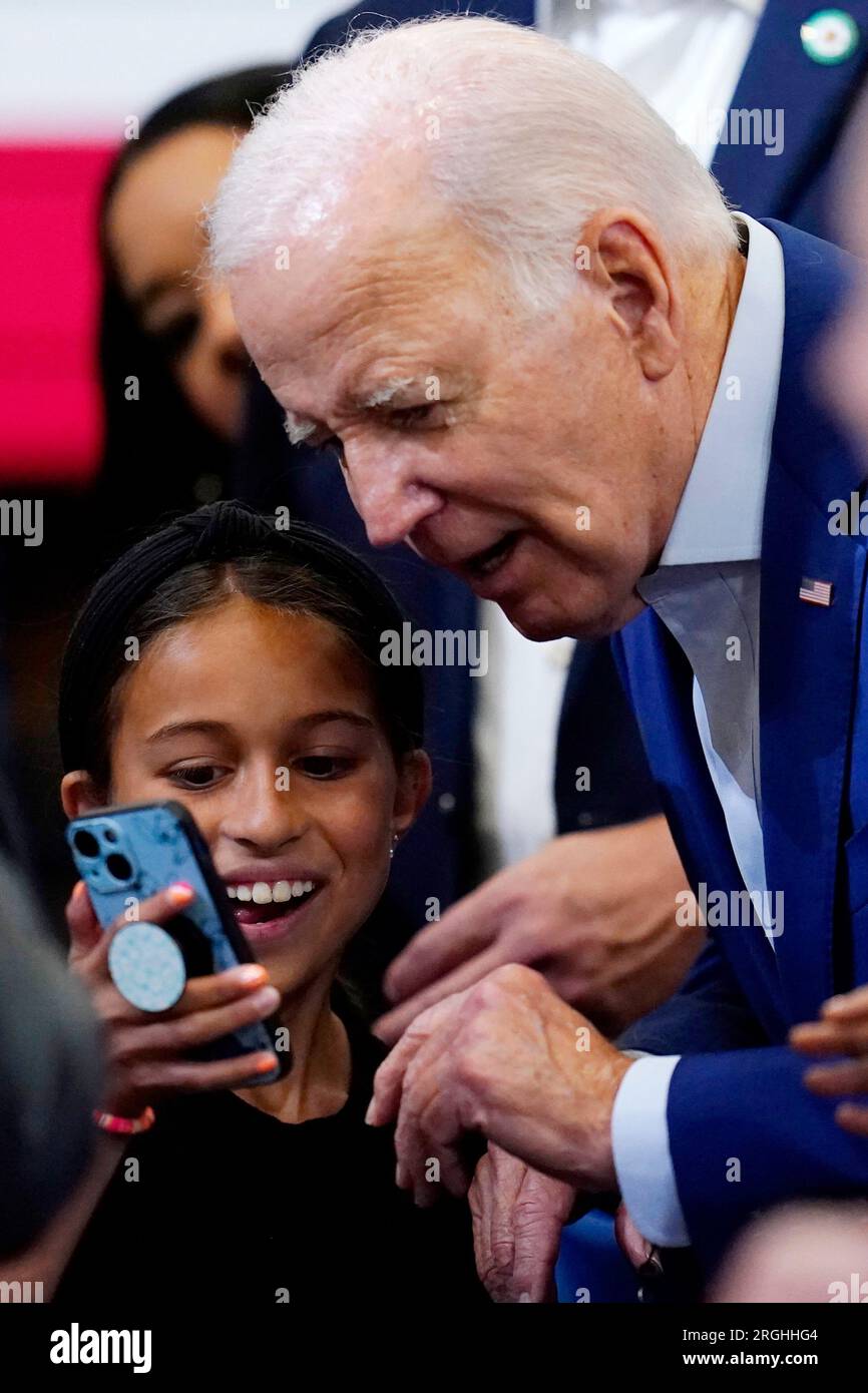 President Joe Biden talks on the phone with a supporter after speaking about the economy at ...
