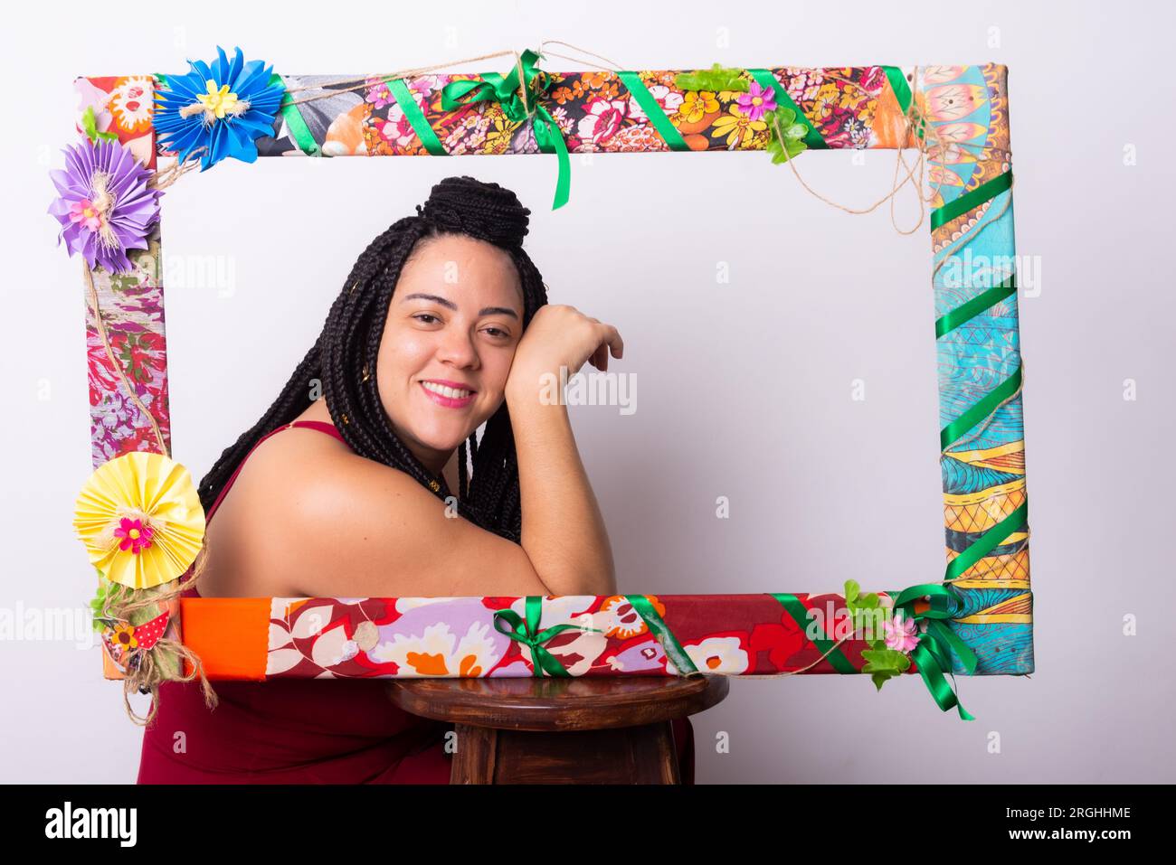 Photo of a beautiful woman with braids in her hair behind a frame ...