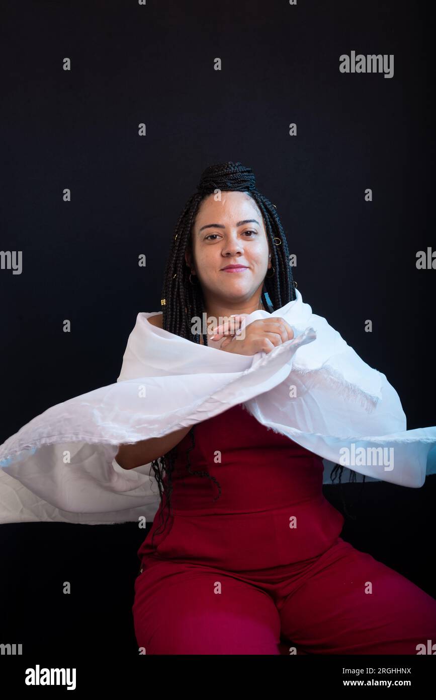 Photo of a beautiful woman with braids in her hair wearing red colored ...