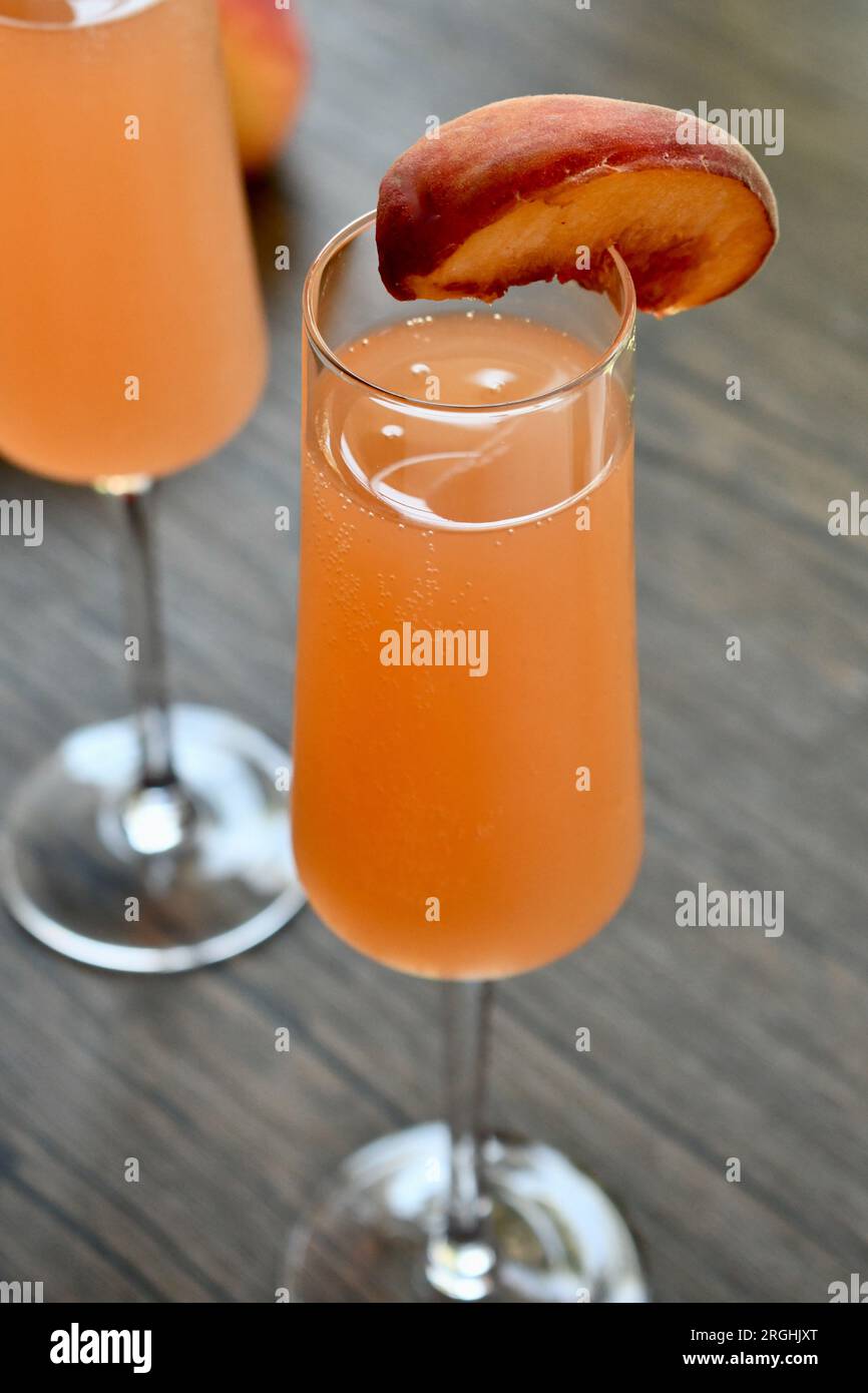 Peach Bellinis on a wood table Stock Photo - Alamy