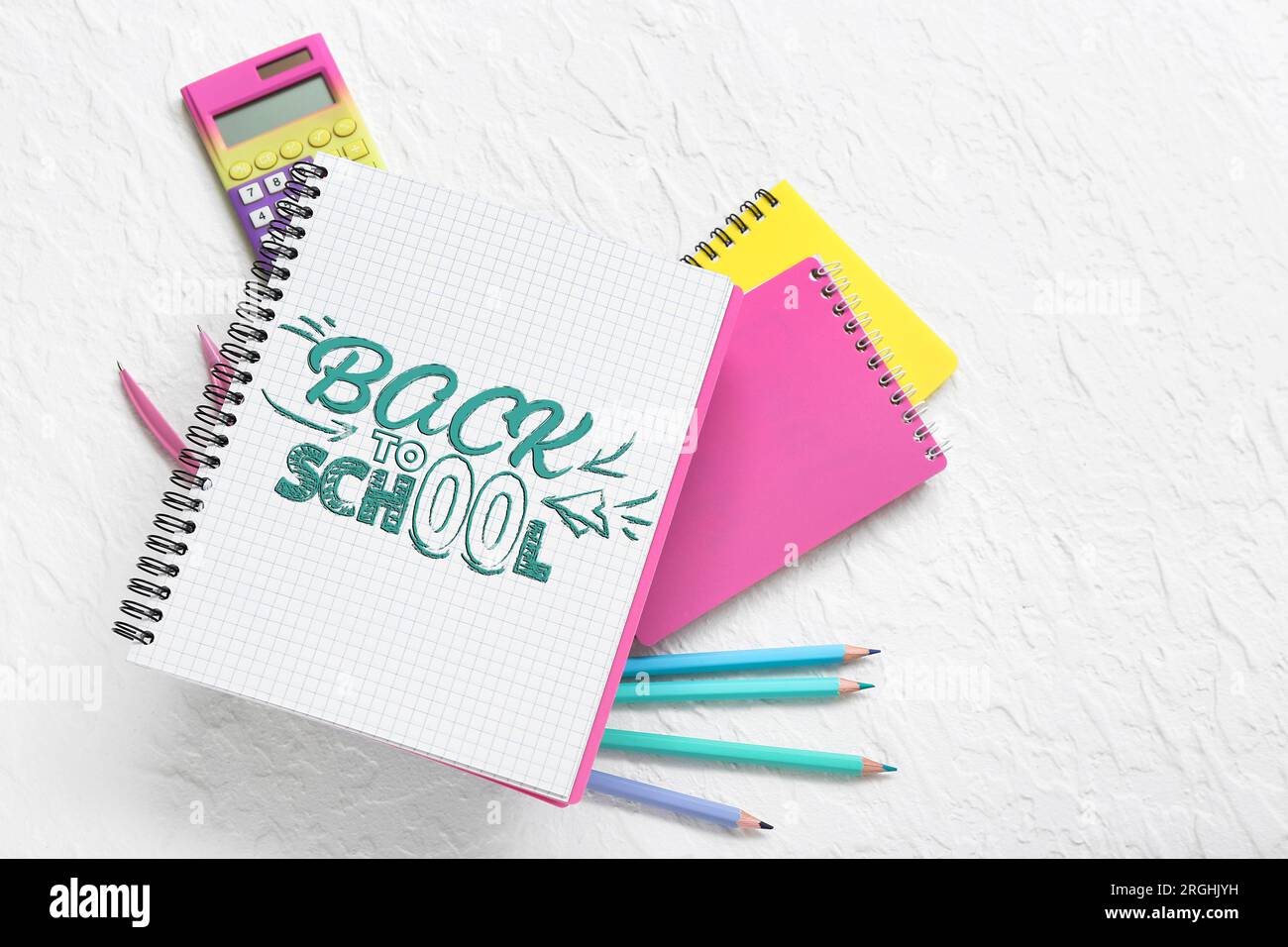 Notebook with text BACK TO SCHOOL and different stationery on white ...