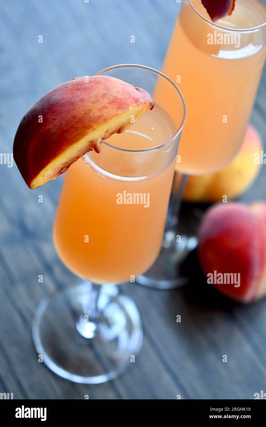 Peach Bellinis on a wood table Stock Photo - Alamy
