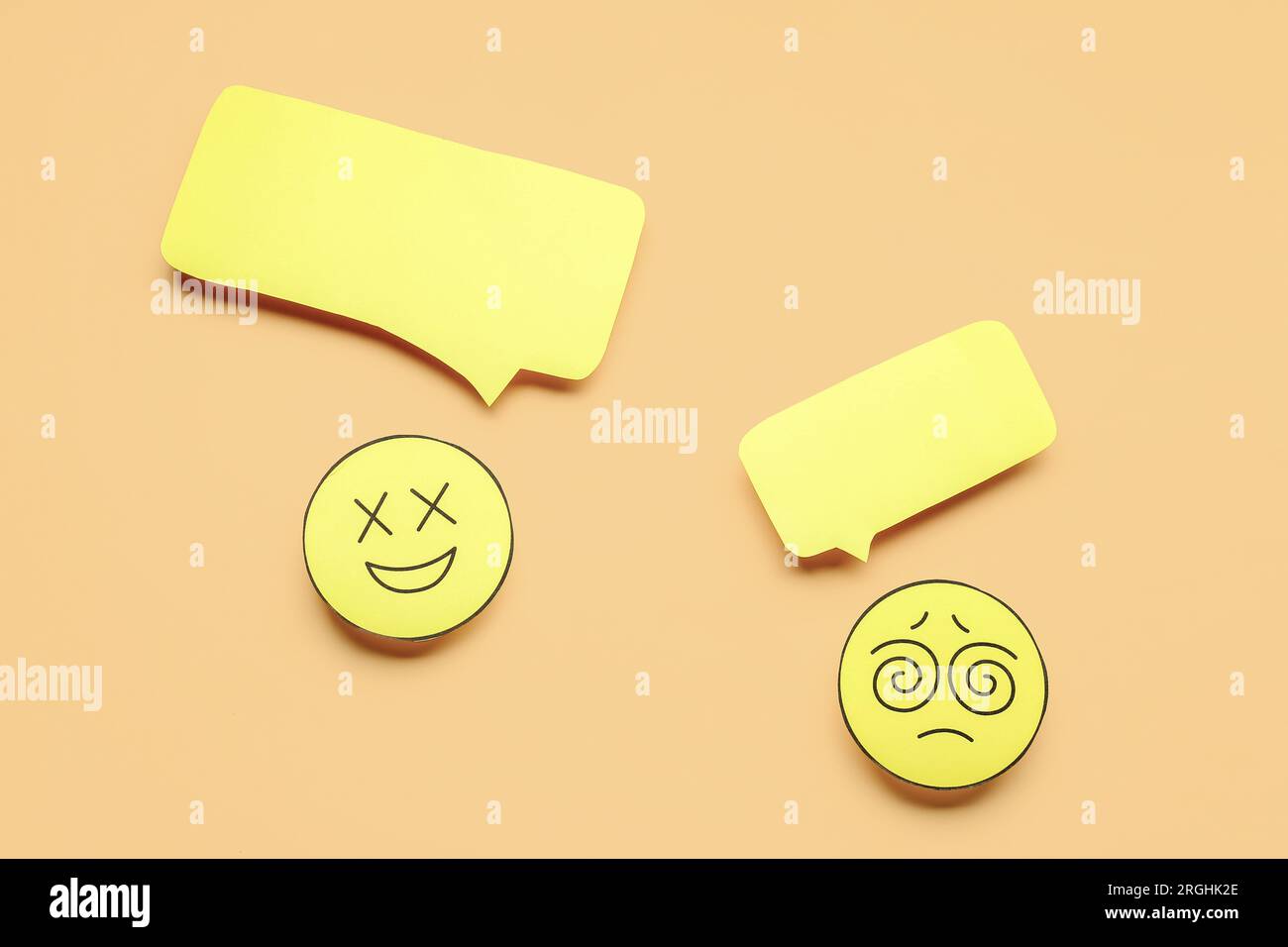 Paper faces with blank speech bubbles on beige background Stock Photo ...