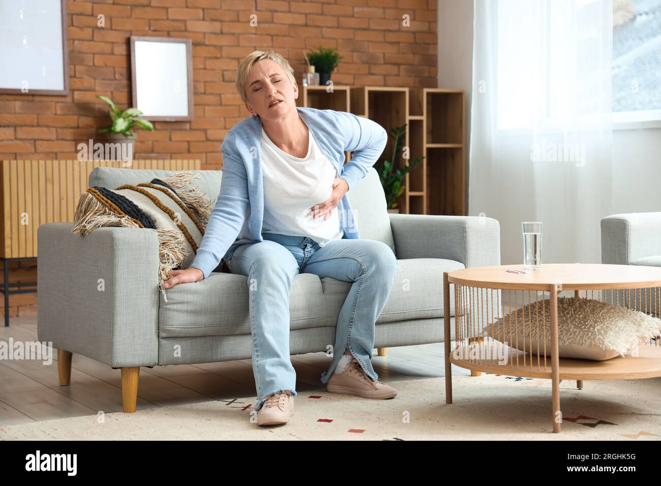 Heart attack aged female sitting hi-res stock photography and images ...