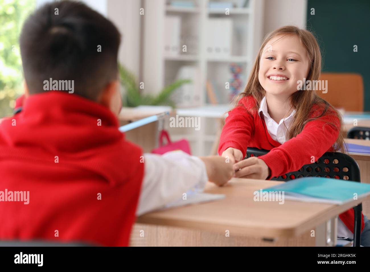 Little girl with her classmate at school Stock Photo - Alamy