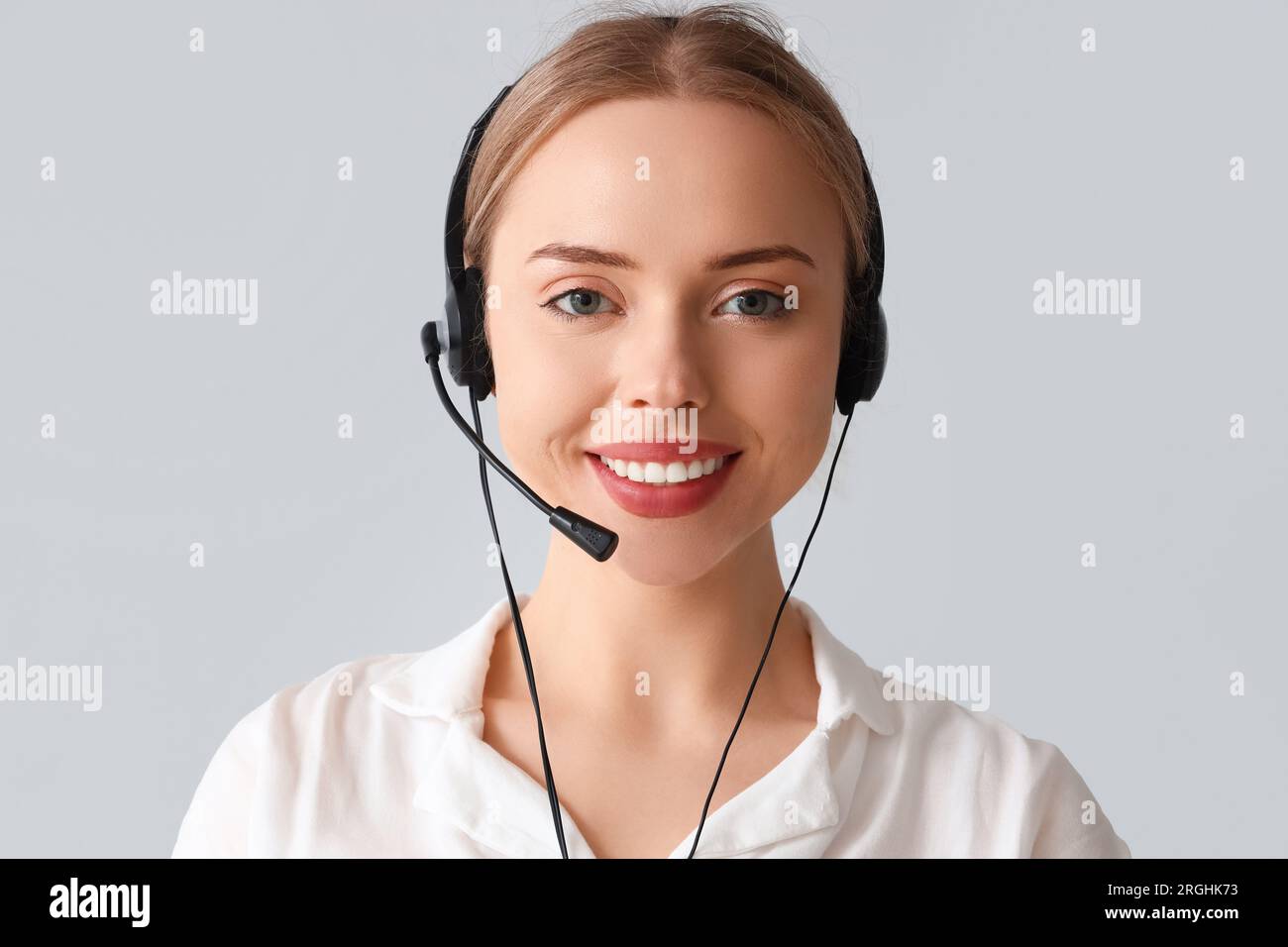 Female technical support agent on light background Stock Photo - Alamy