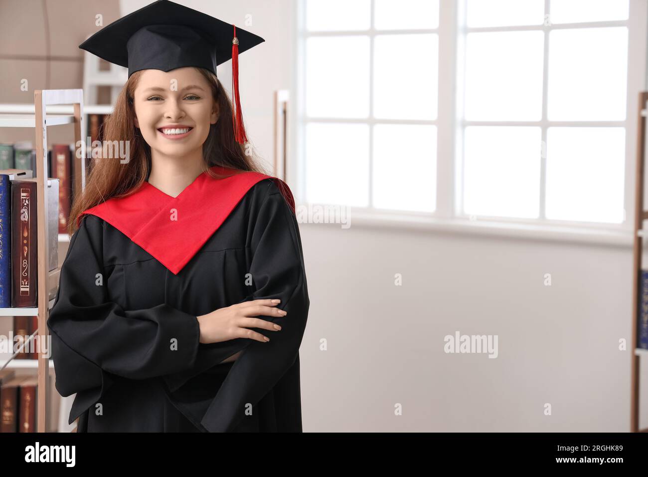Female graduate student in library Stock Photo - Alamy